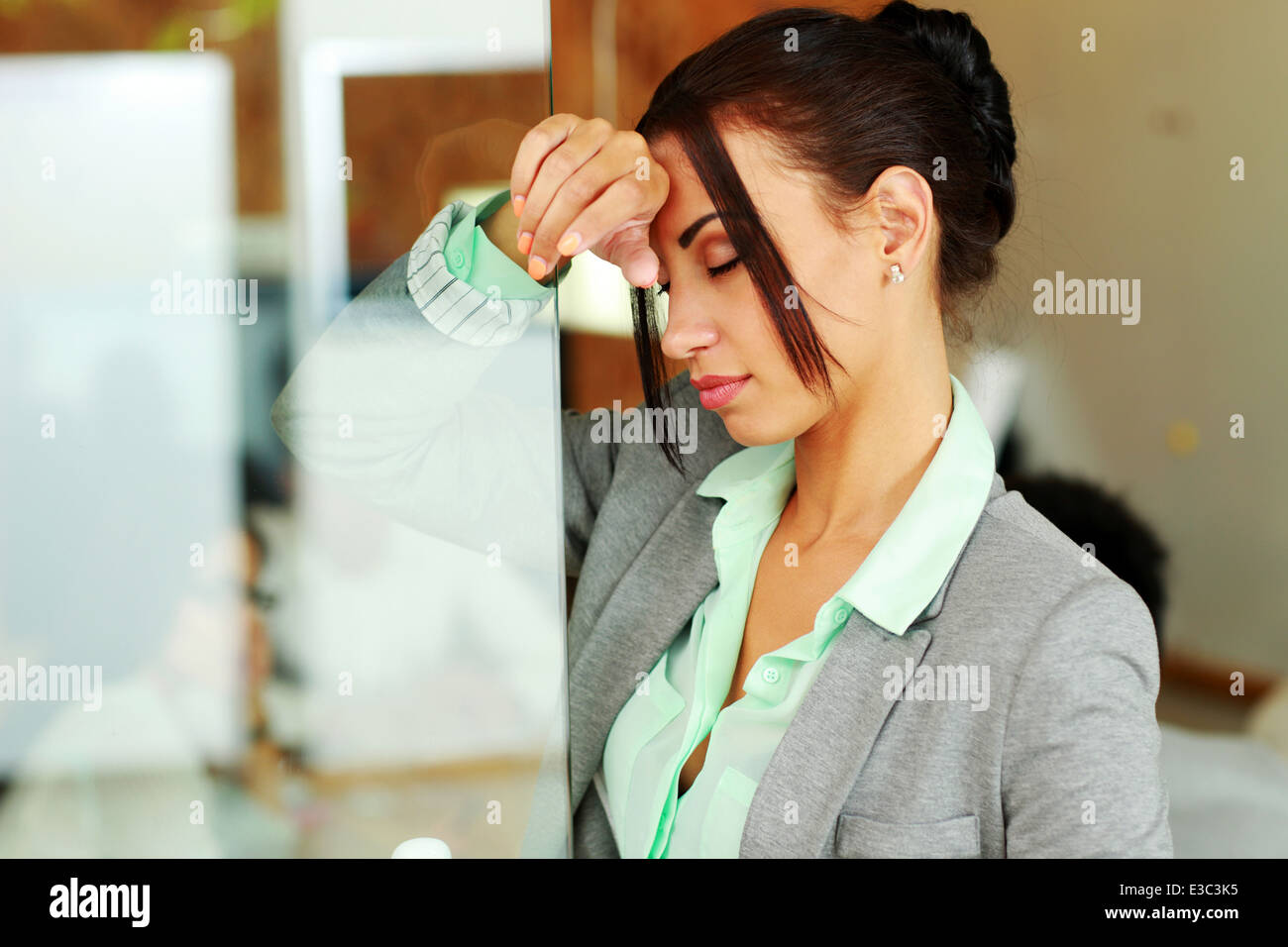 Portrait of a beautiful tired businesswoman Stock Photo - Alamy