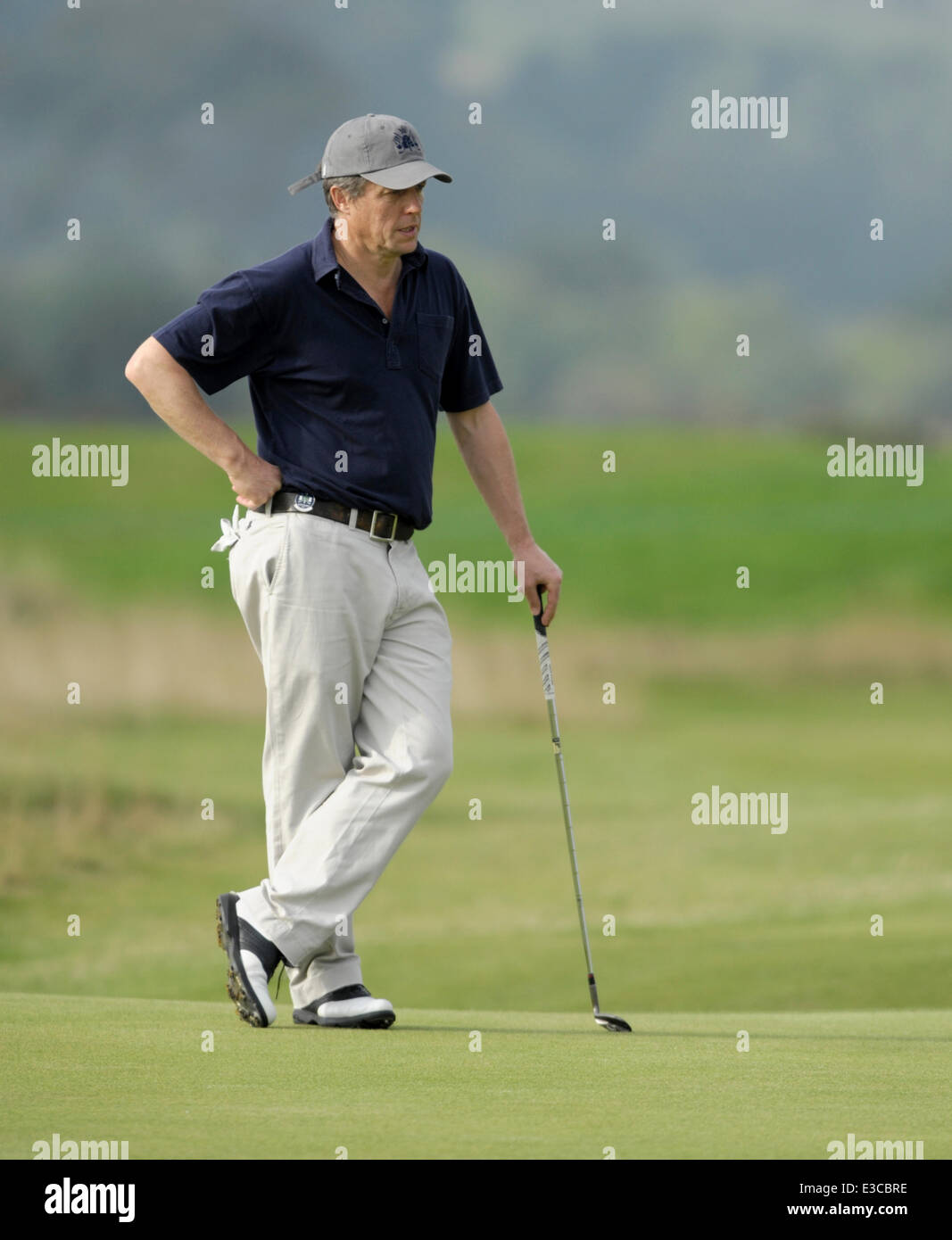 Actor Hugh Grant plays golf in the Alfred Dunhill Links Championship in ...
