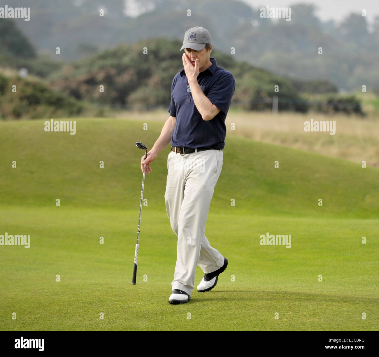 Actor Hugh Grant plays golf in the Alfred Dunhill Links Championship in ...