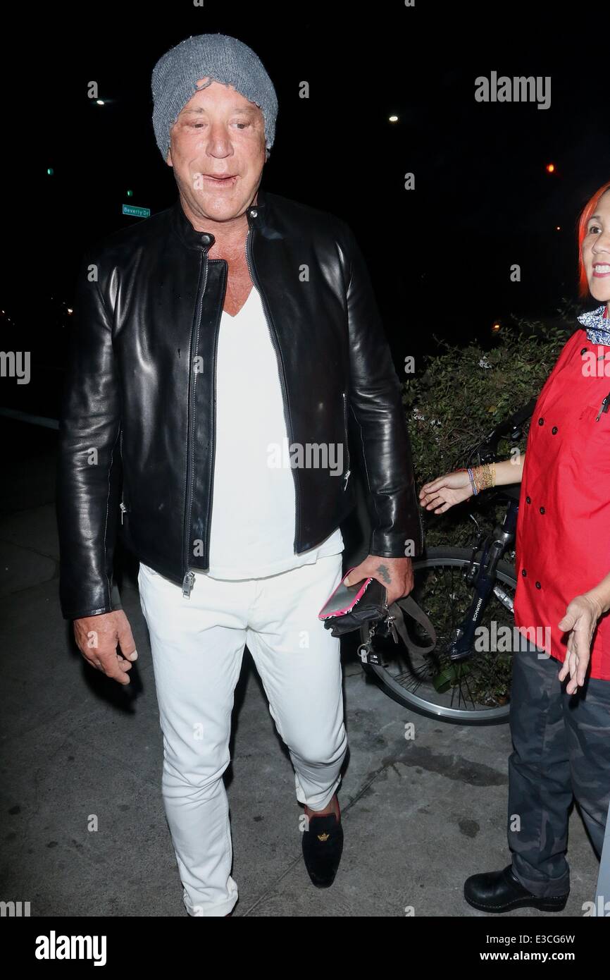 Micky Rourke wearing white trousers, black leather jacket and a tatty ...