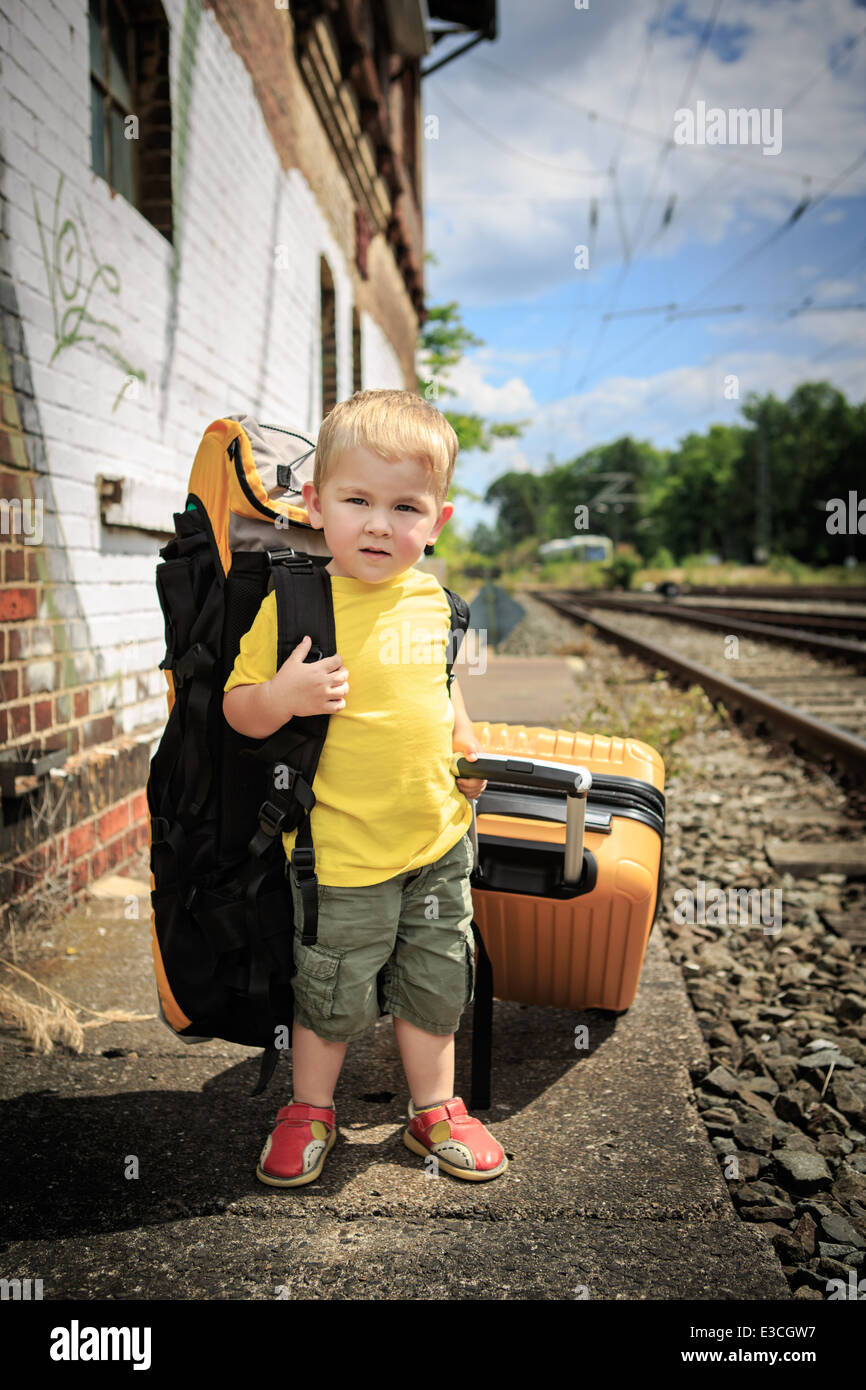 little boy waiting for the train on a railway station Stock Photo - Alamy