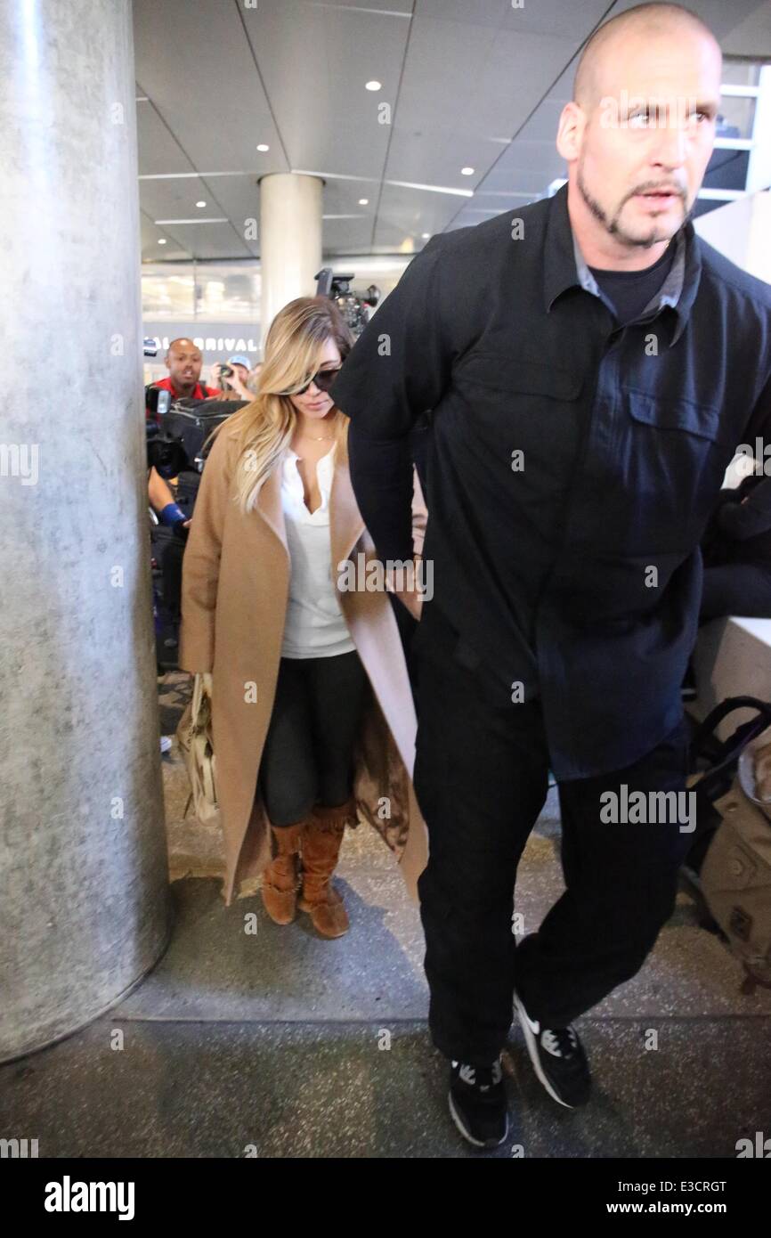 Kim Kardashian arrives at LAX on an international flight with a ...