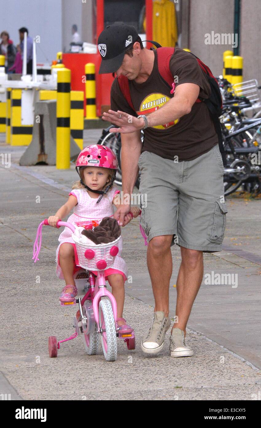 Jason Hoppy takes his daughter Bryne Hoppy for a bike ride on her pink ...