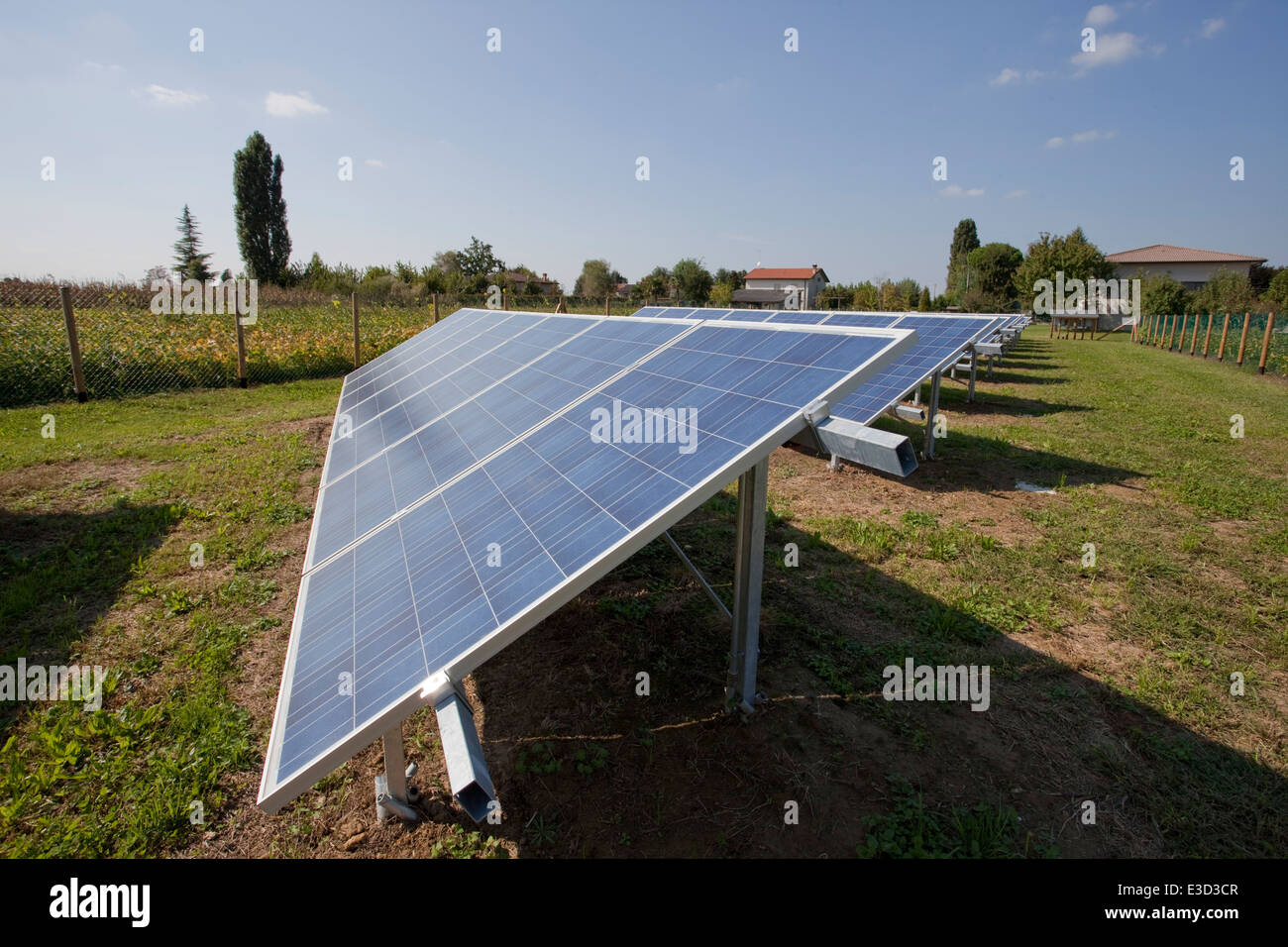 Ecology electric energy farm with solar panel battery in green field ...