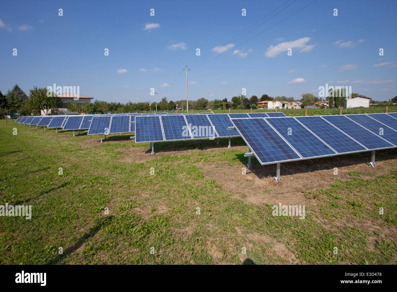 Ecology electric energy farm with solar panel battery in green field ...