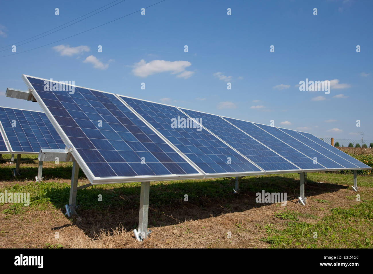 Ecology electric energy farm with solar panel battery in green field ...