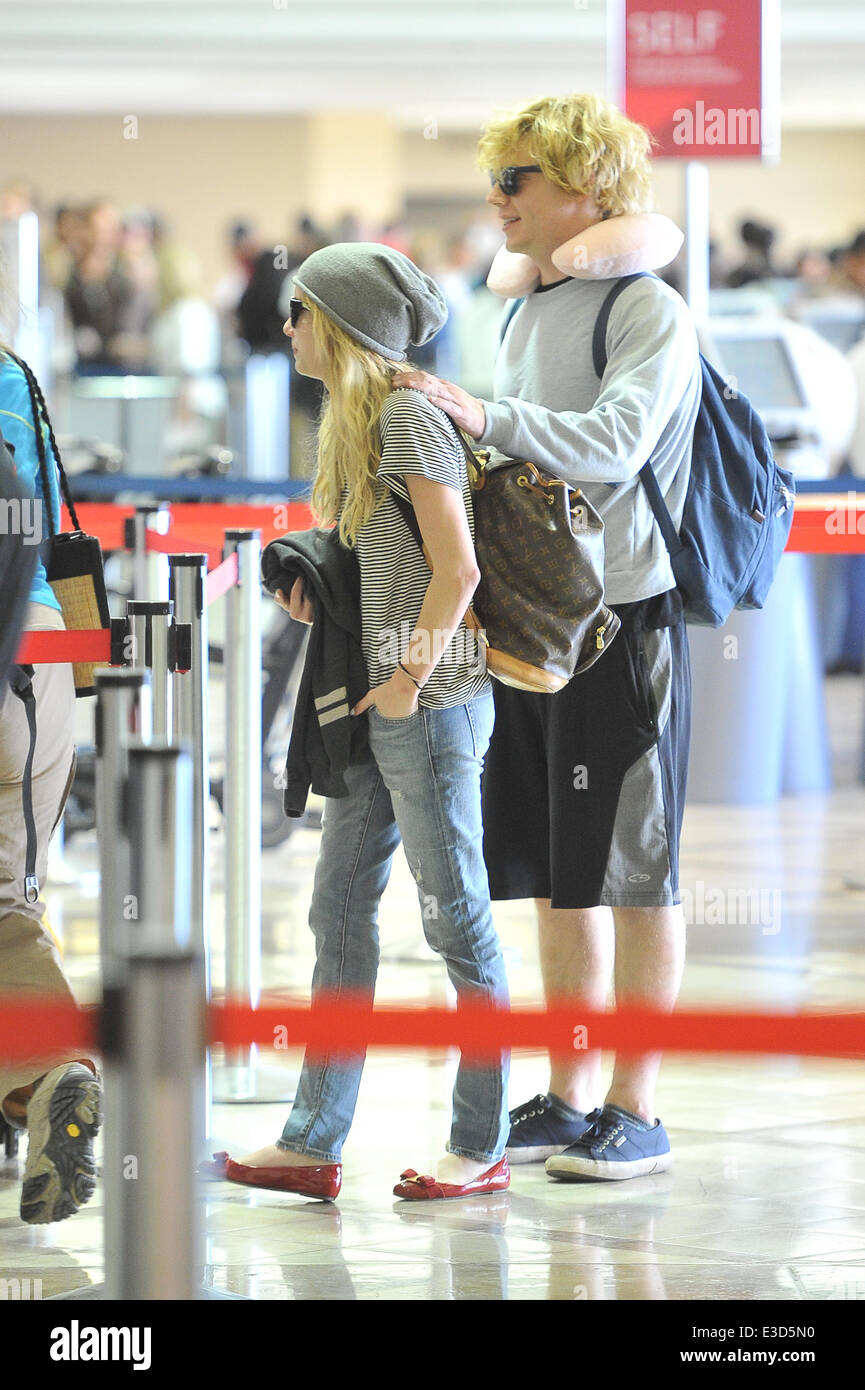Emma Roberts and her boyfriend Evan Peters pack on the PDA at LAX as they catch a flight out of ...