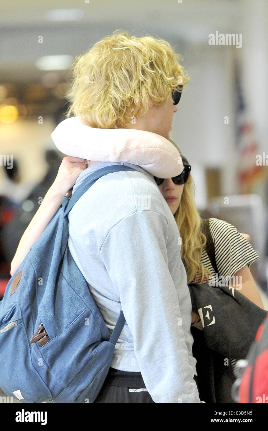 Emma Roberts and her boyfriend Evan Peters pack on the PDA at LAX as they catch a flight out of ...