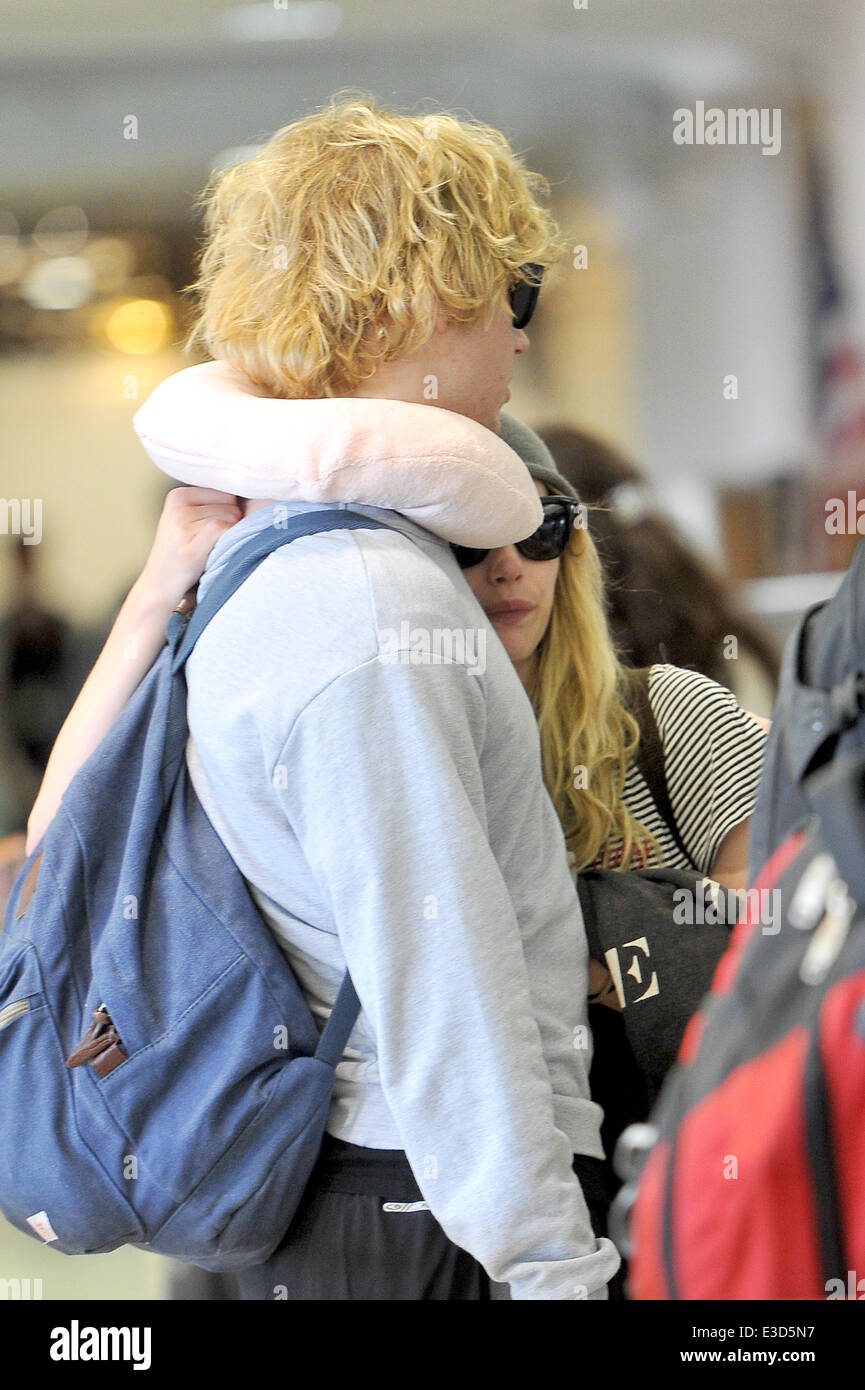 Emma Roberts and her boyfriend Evan Peters pack on the PDA at LAX as ...
