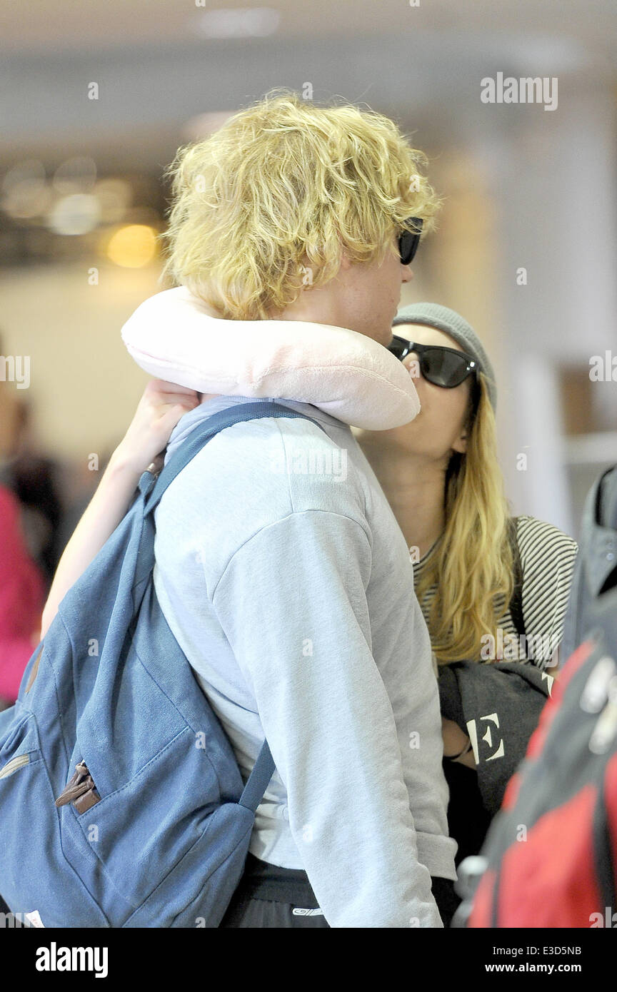 Emma Roberts and her boyfriend Evan Peters pack on the PDA at LAX as ...