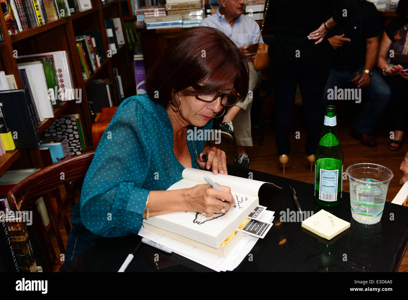 Bookstore owner and Cuban cookbook author Raquel Roque greets fans and ...
