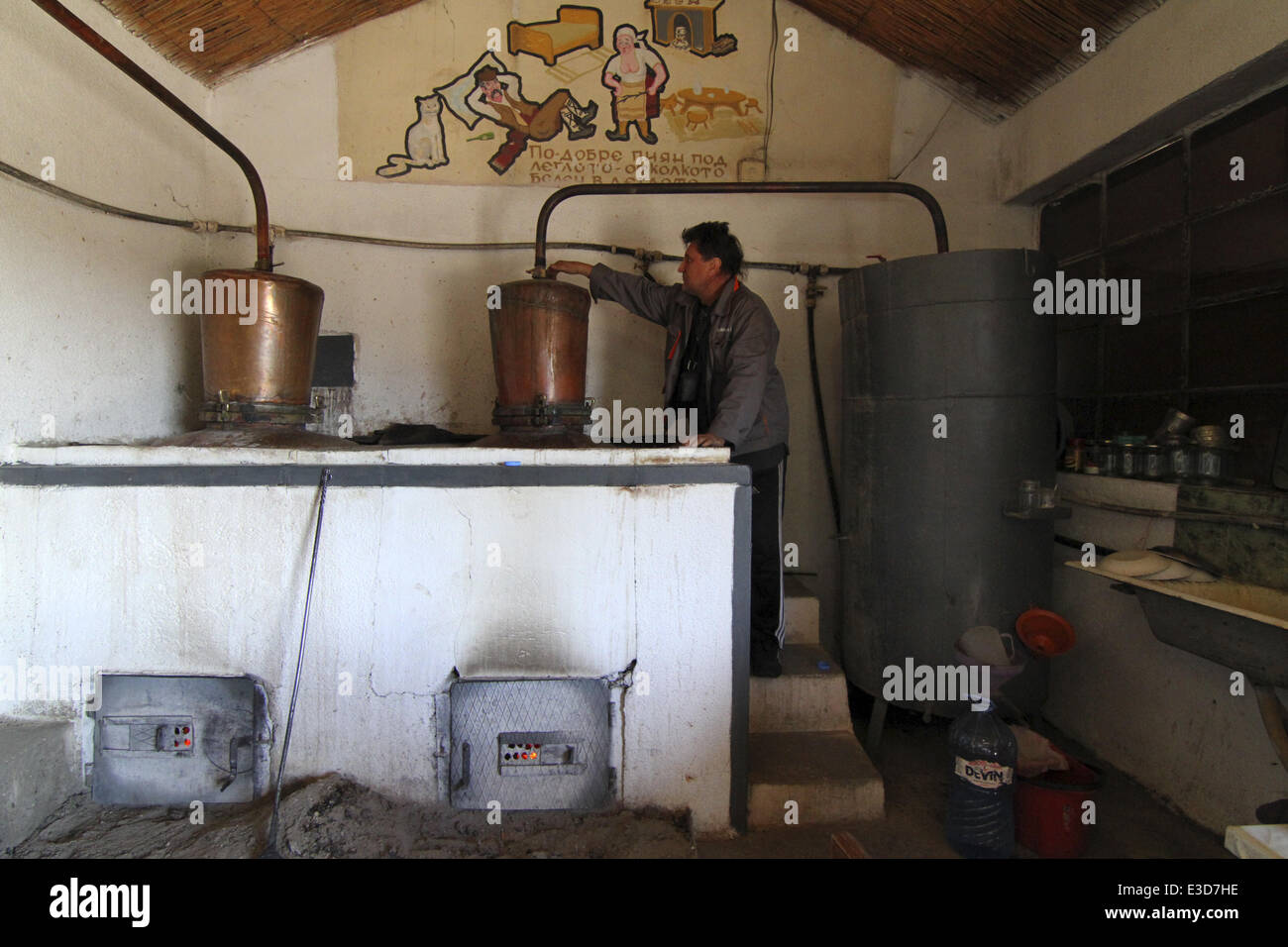 A Bulgarian man checks the alcoholic quality at a small home raki ...