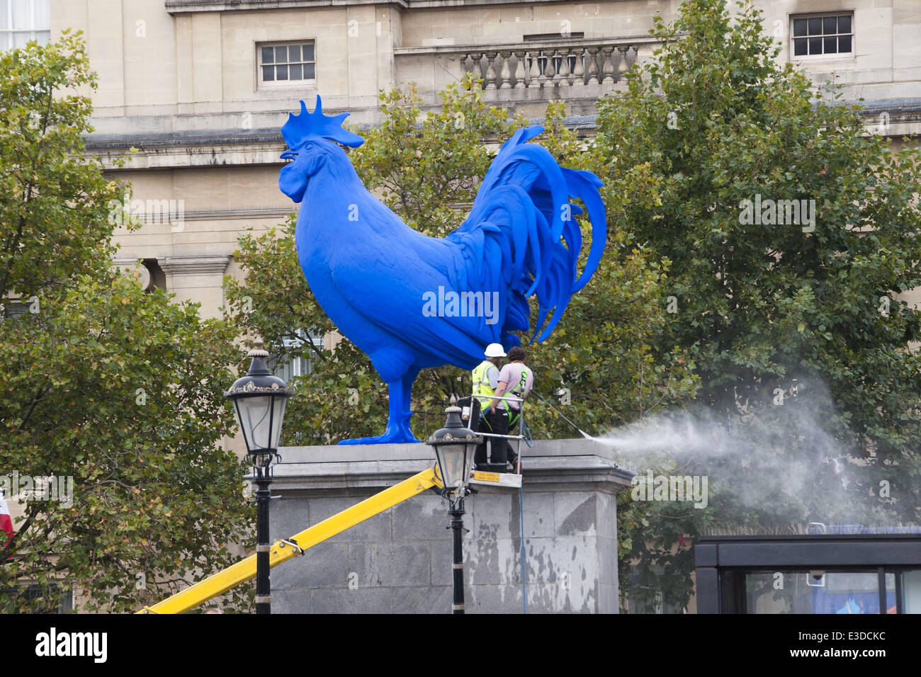 A blue French cockerel by German artist Katharina Fritsch is cleaned ...