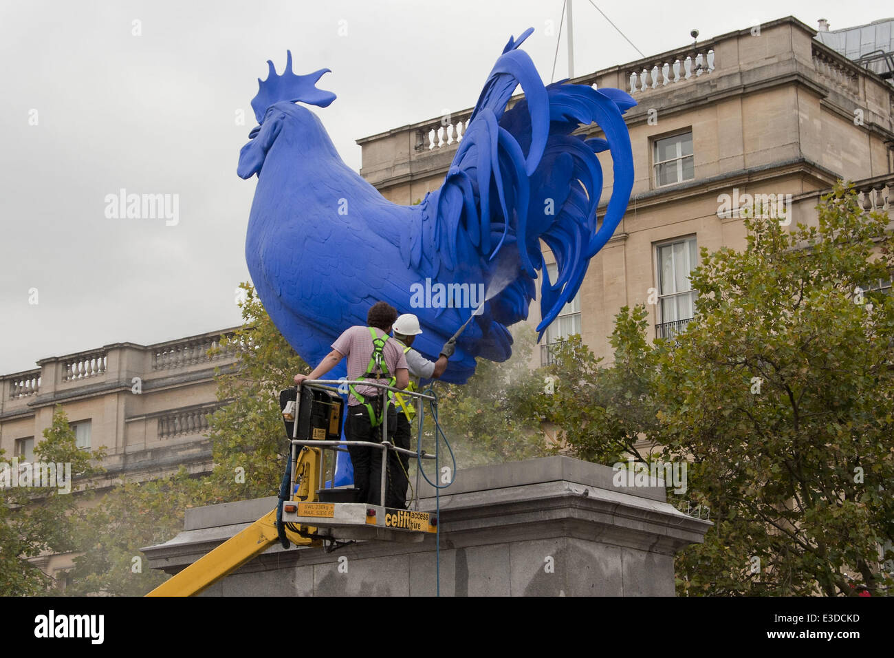 A blue French cockerel by German artist Katharina Fritsch is cleaned ...