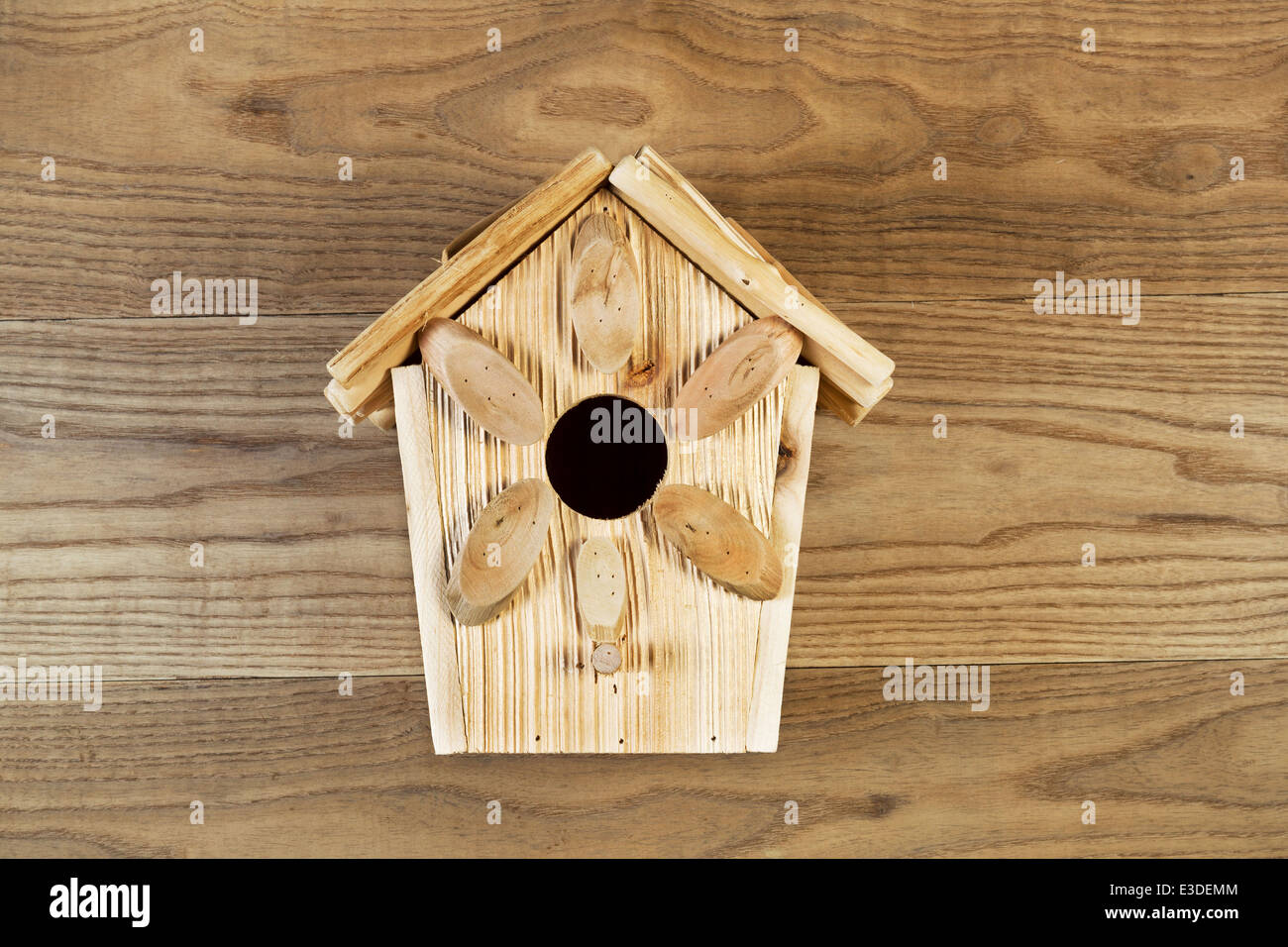 Overhead view of new wooden birdhouse on rustic wood Stock Photo - Alamy