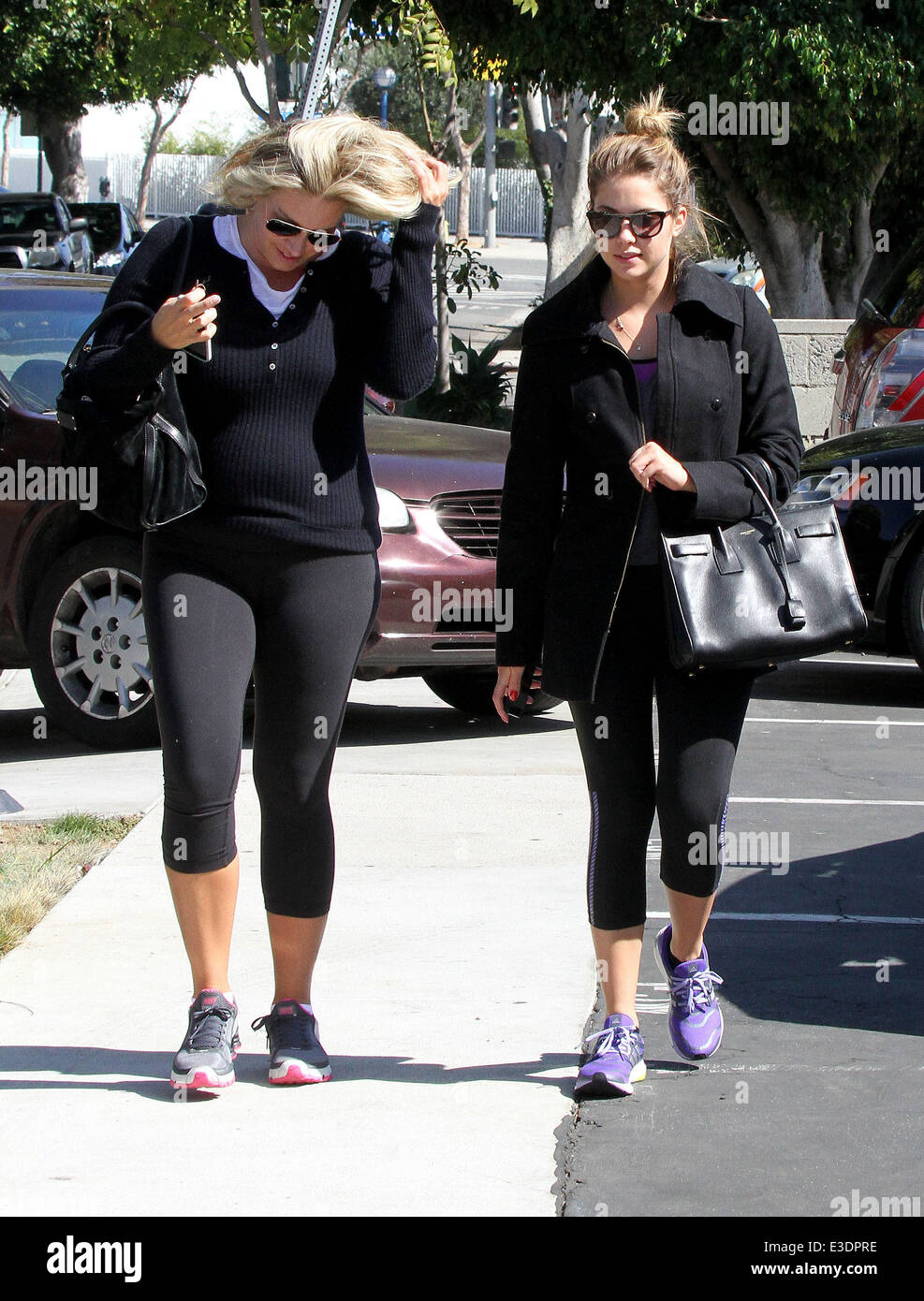 Ashley Benson, wearing a winter coat, arrives at a gym for a workout ...