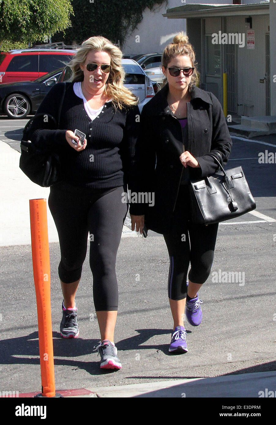 Ashley Benson, wearing a winter coat, arrives at a gym for a workout ...