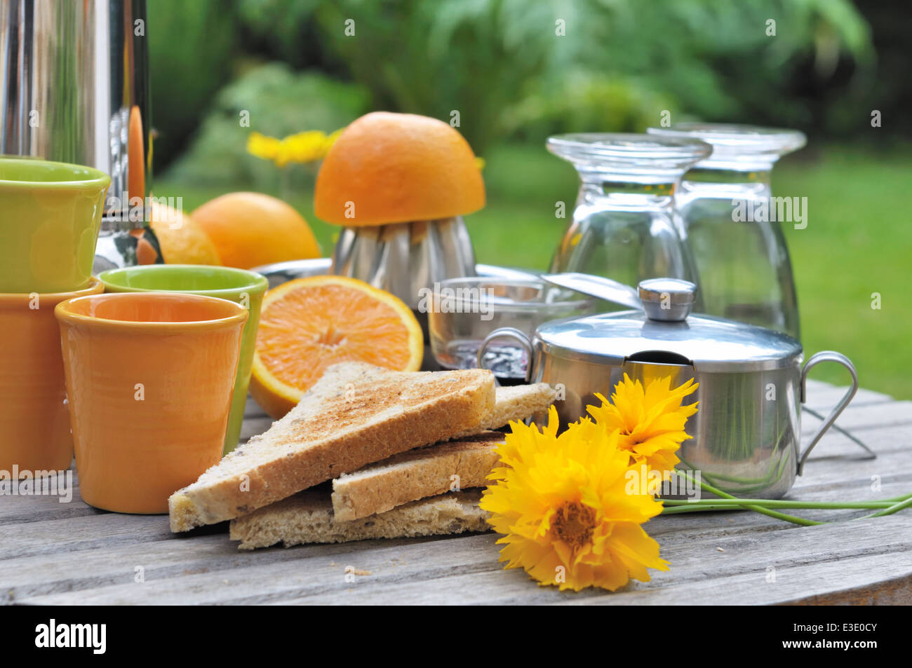 ingredients and crockery for breakfast in the garden with flowers Stock ...