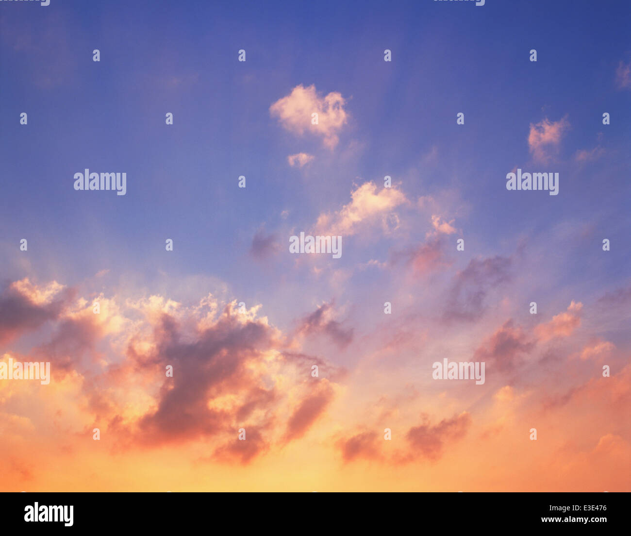 Sunset through clouds Stock Photo - Alamy