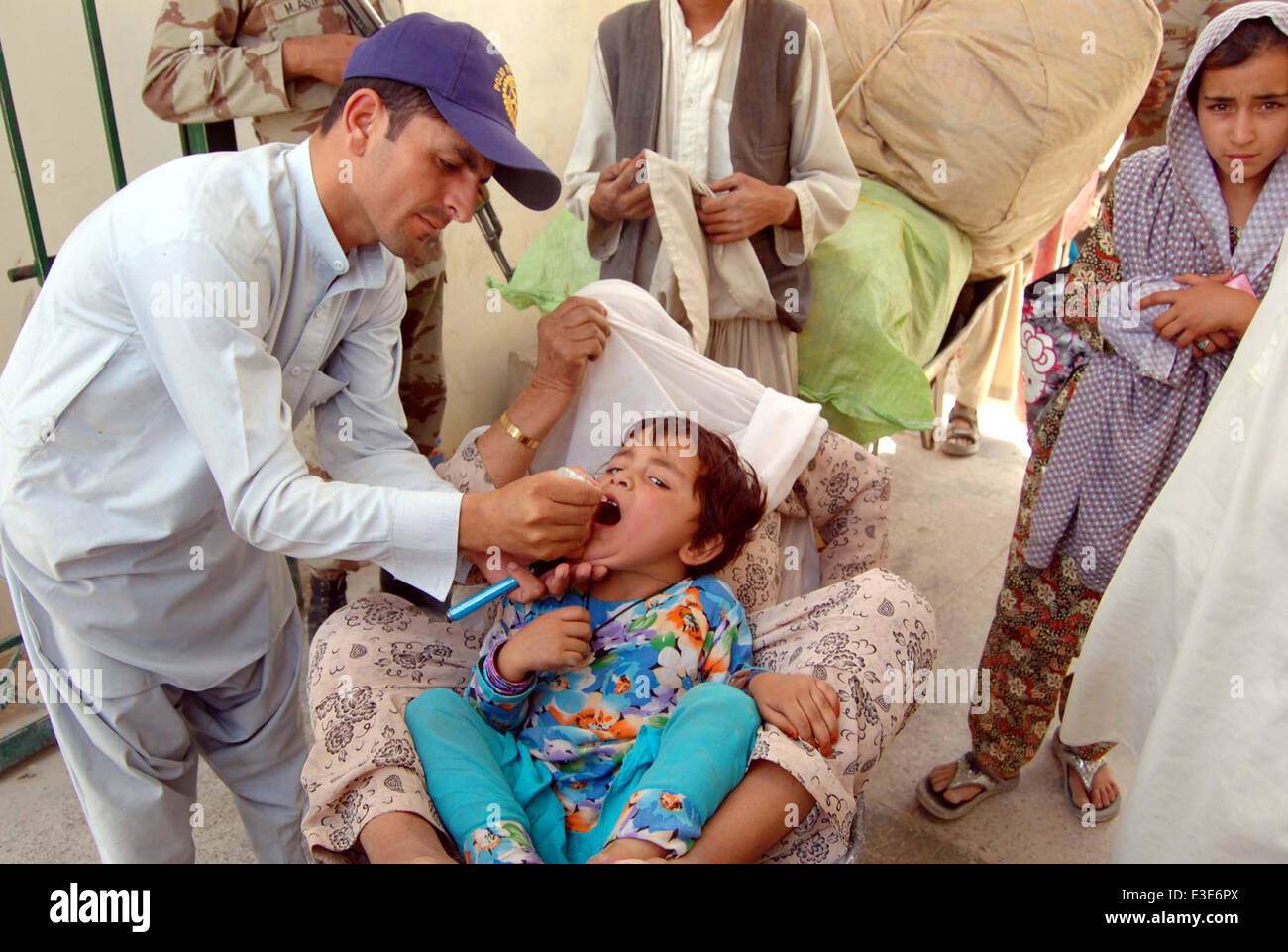 Health worker administrates polio-vaccine drops to a child during anti ...
