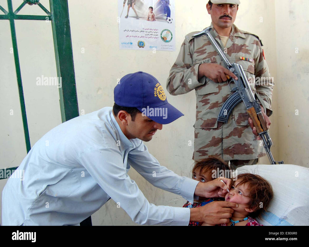 Health worker administrates polio-vaccine drops to a child during anti ...