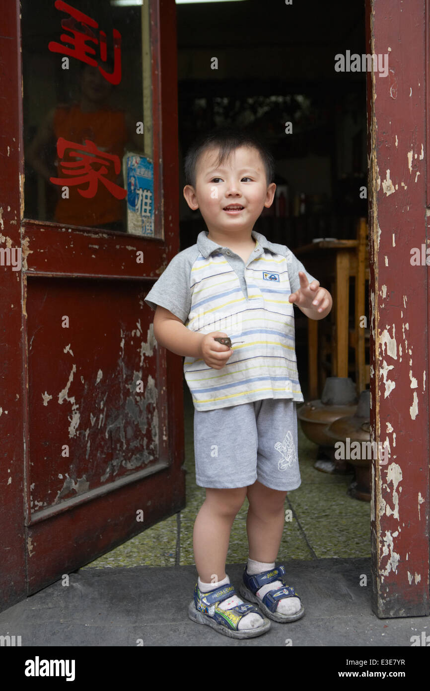 Young chinese boy standing in doorway, Beijing, China Stock Photo - Alamy