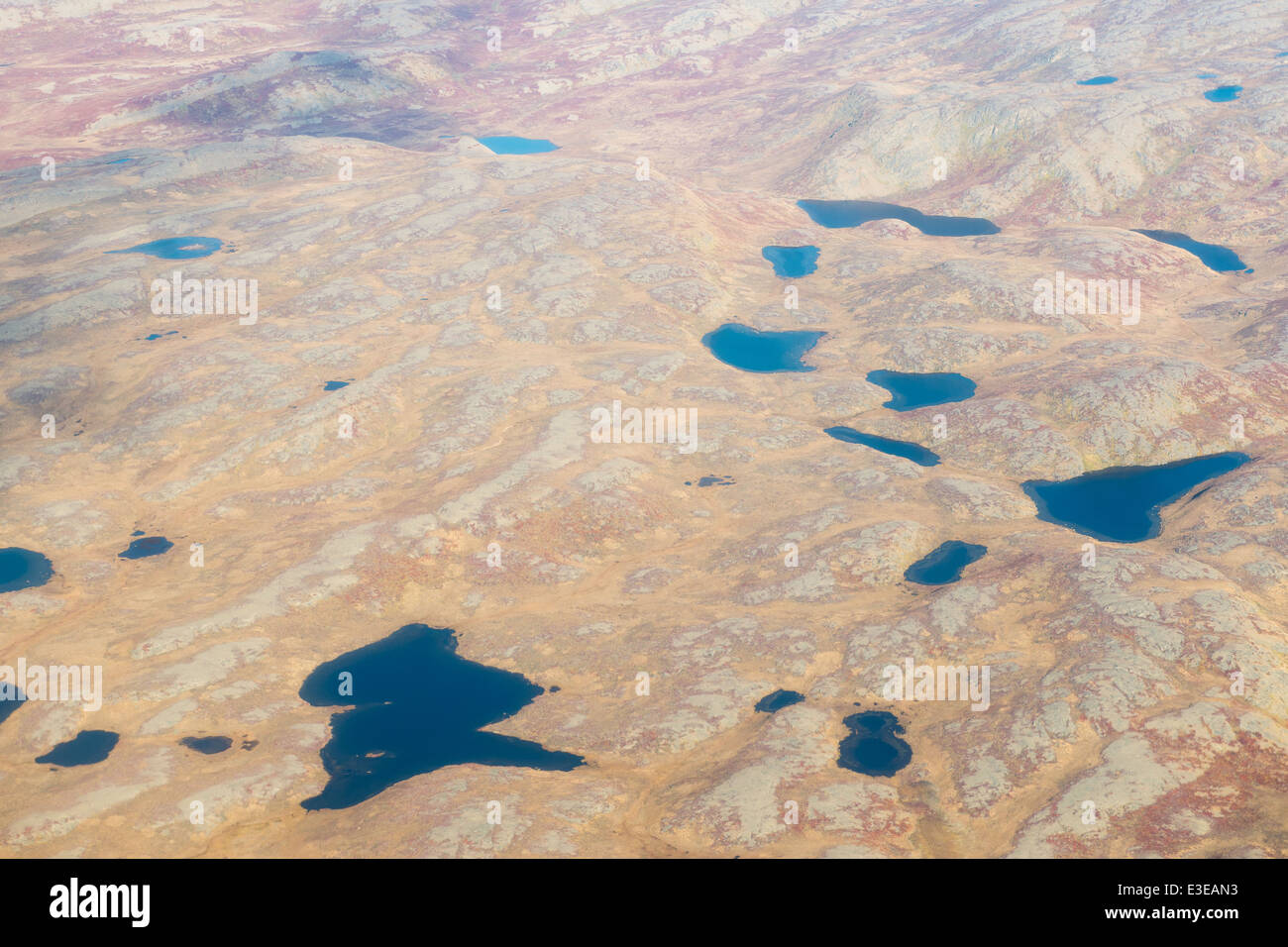 Landscape of Greenland seen from the air in summer with rocky surface ...
