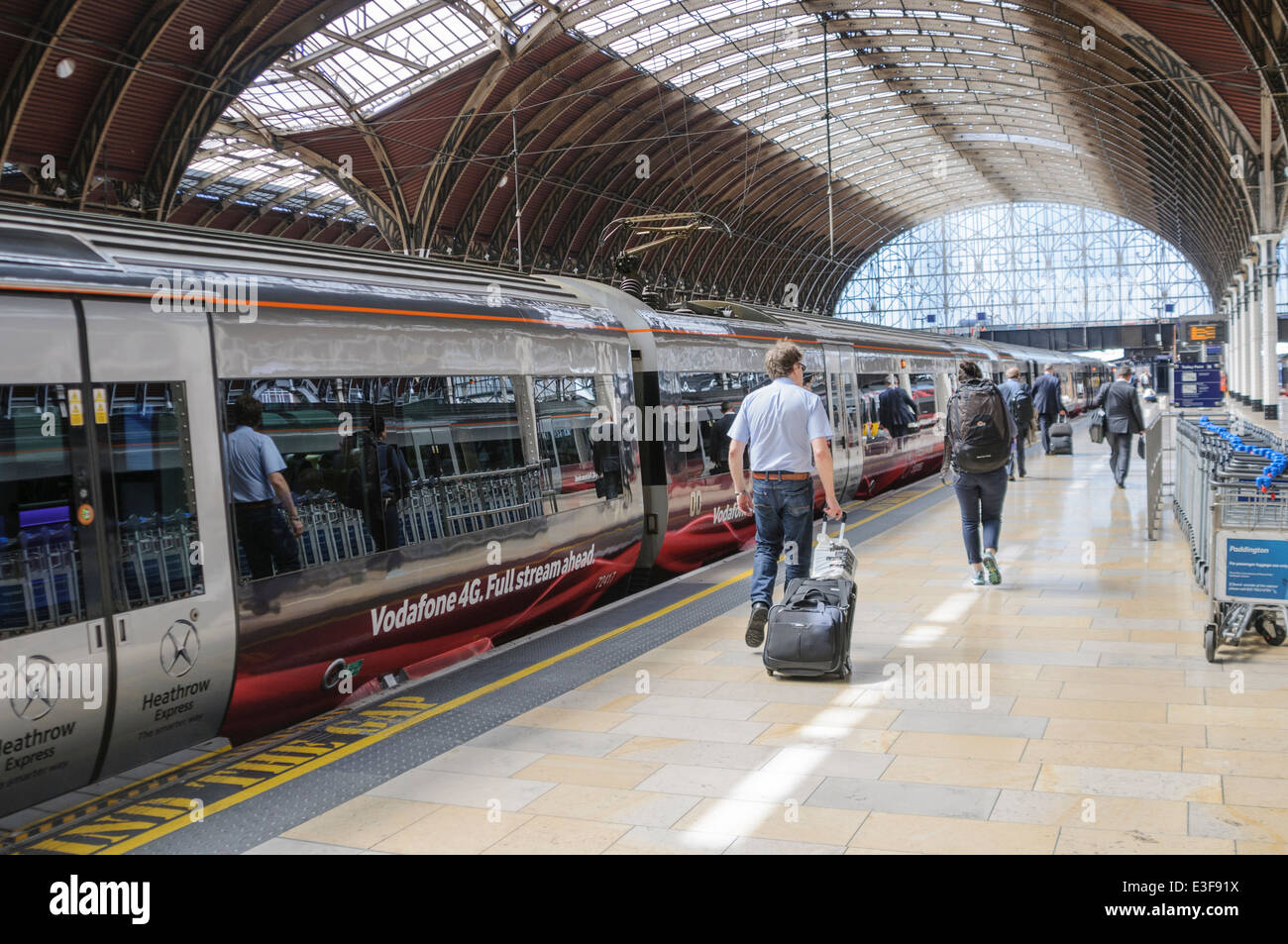 Commuters walk along the platform to board the Heathrow Express at ...