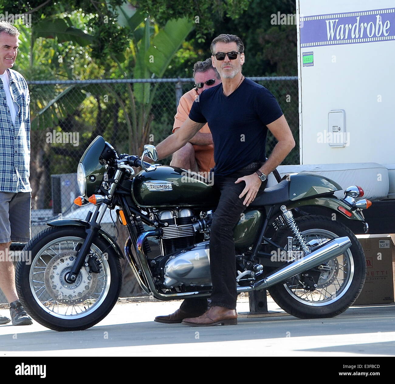 Pierce Brosnan checks out a classic motorcycle while on the set of 'How ...