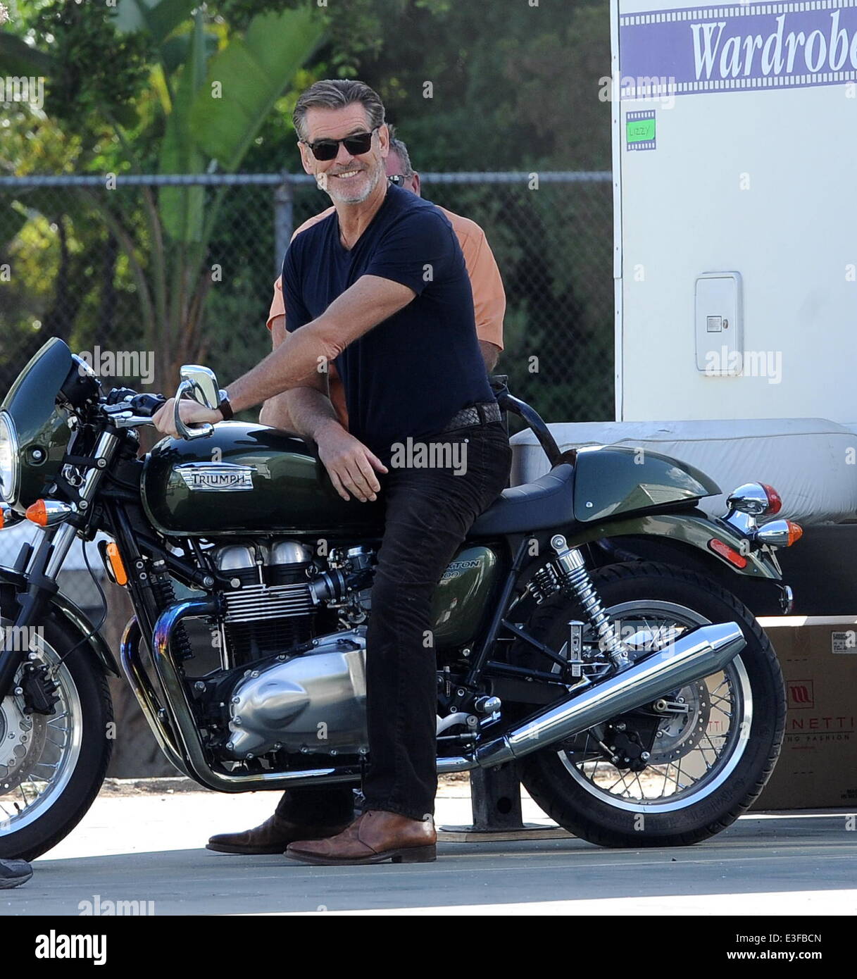 Pierce Brosnan checks out a classic motorcycle while on the set of 'How ...
