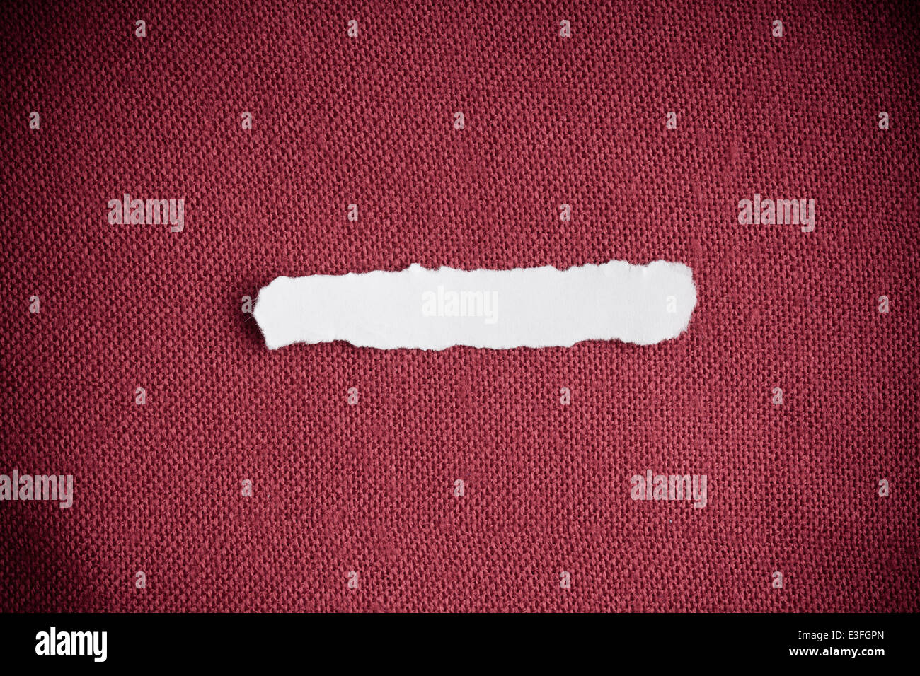 Piece scrap of white paper blank copy space on red fabric textile ...