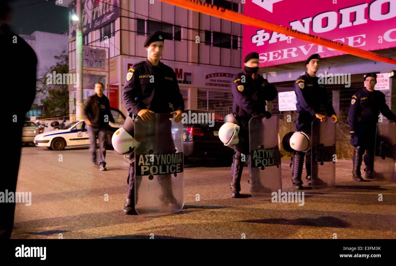Police forces secure the crime scene outside the Golden Dawn offices as ...