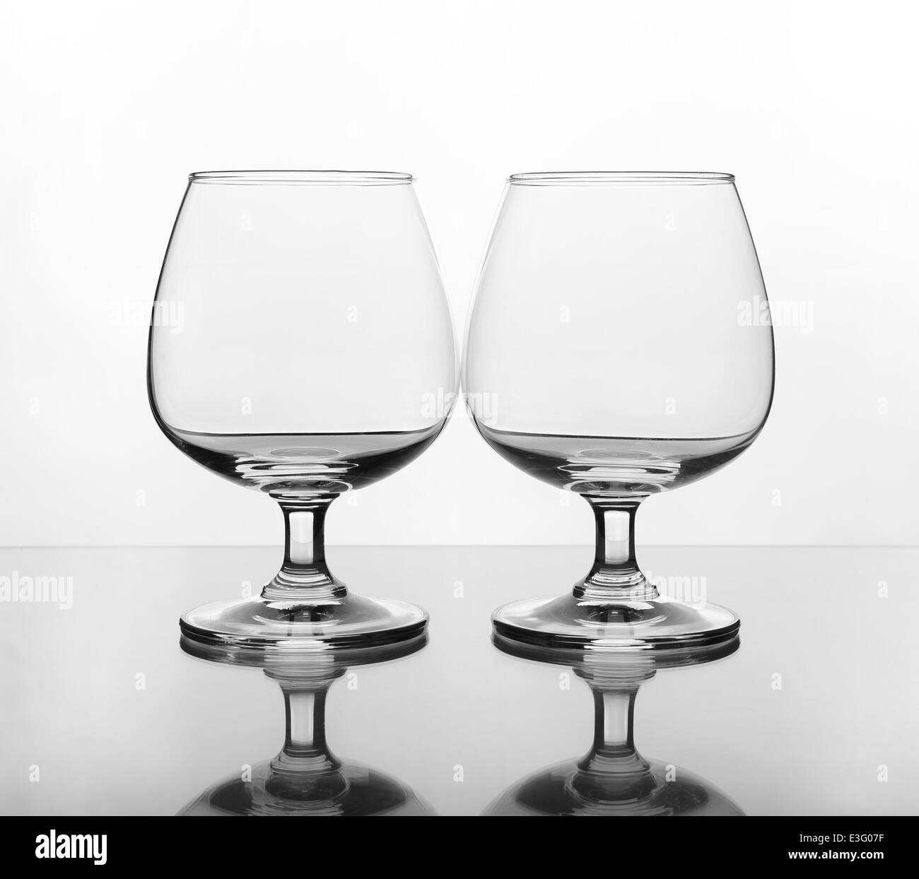 two empty wine glass on glass table (gray scale Stock Photo - Alamy