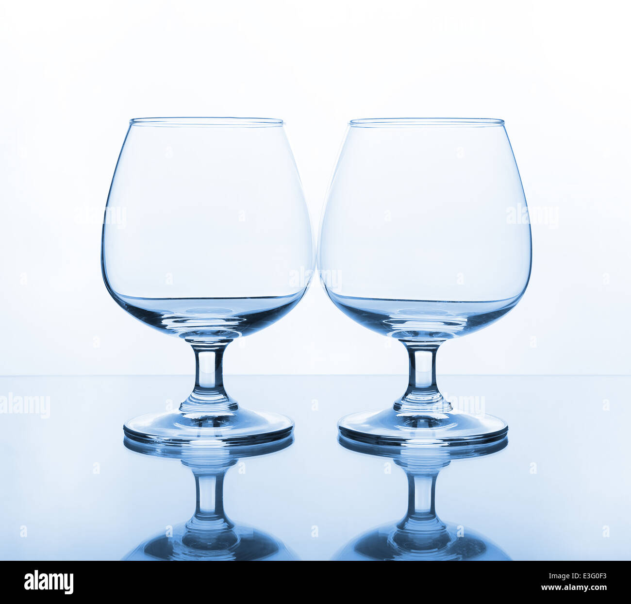 two empty wine glass on glass table Stock Photo - Alamy