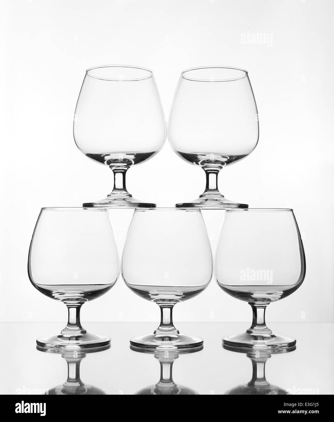 stack of empty wine glass on glass table (gray scale Stock Photo - Alamy