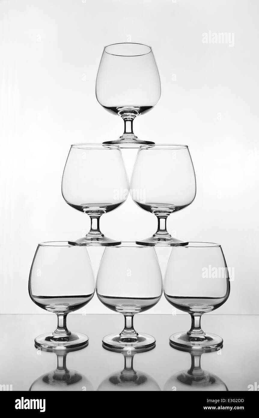 stack of empty wine glass on glass table (gray scale Stock Photo - Alamy
