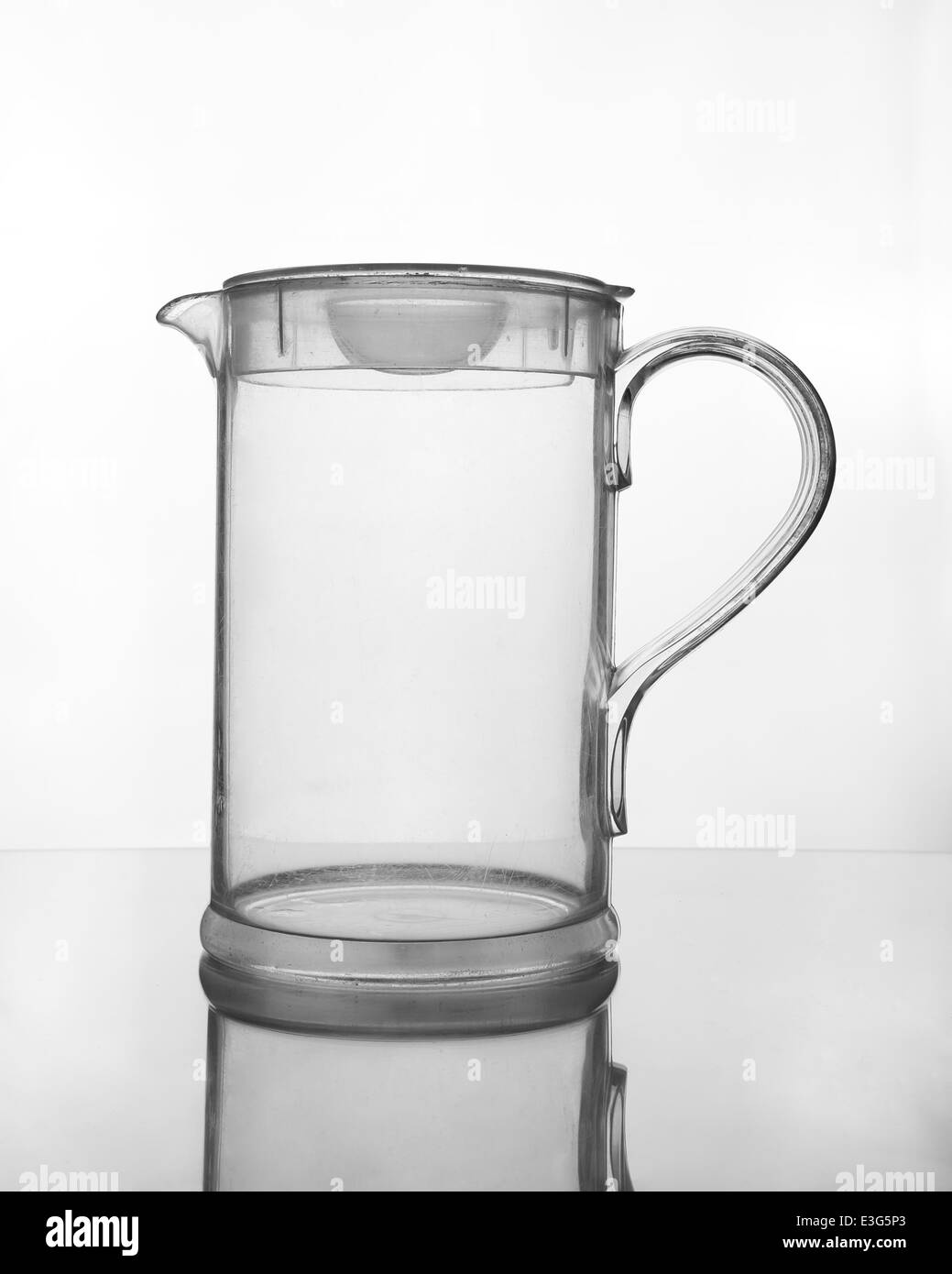 empty glass jug on glass table (gray scale Stock Photo - Alamy