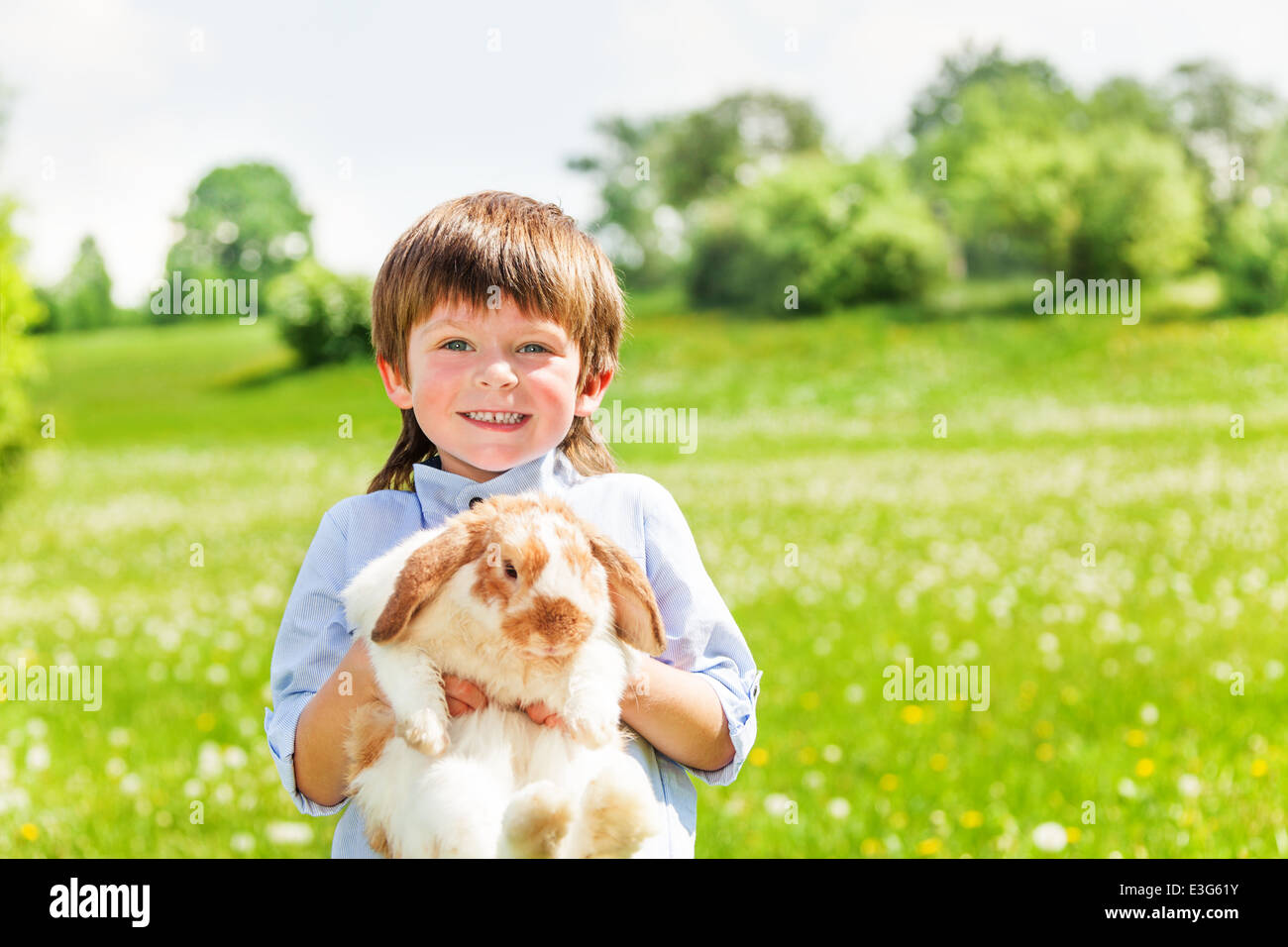 Smiling kid with cute rabbit in summer Stock Photo - Alamy