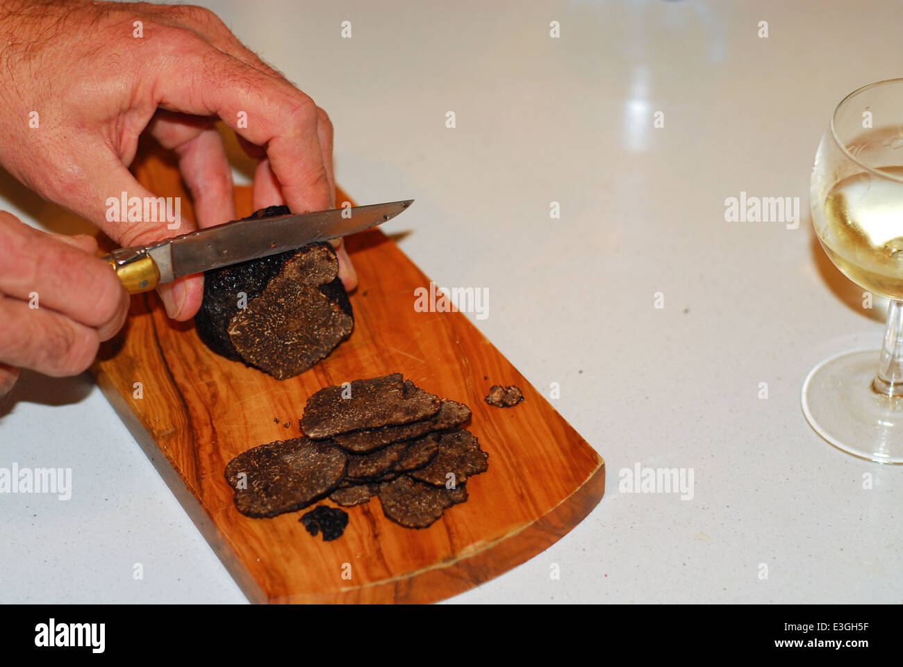A person cutting a large black truffle Stock Photo - Alamy