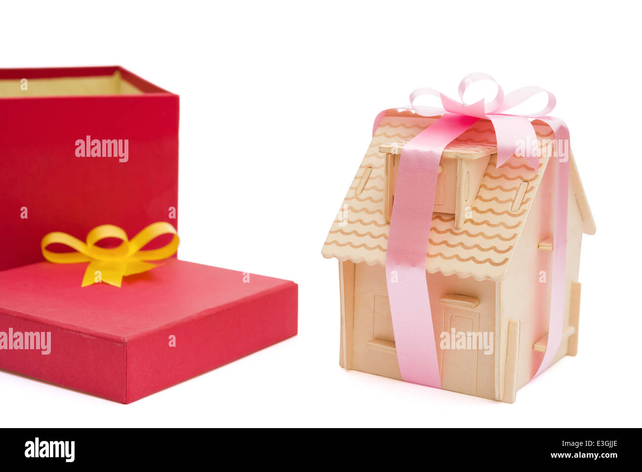 house wrapped with ribbon besides a present box with clipping path ...