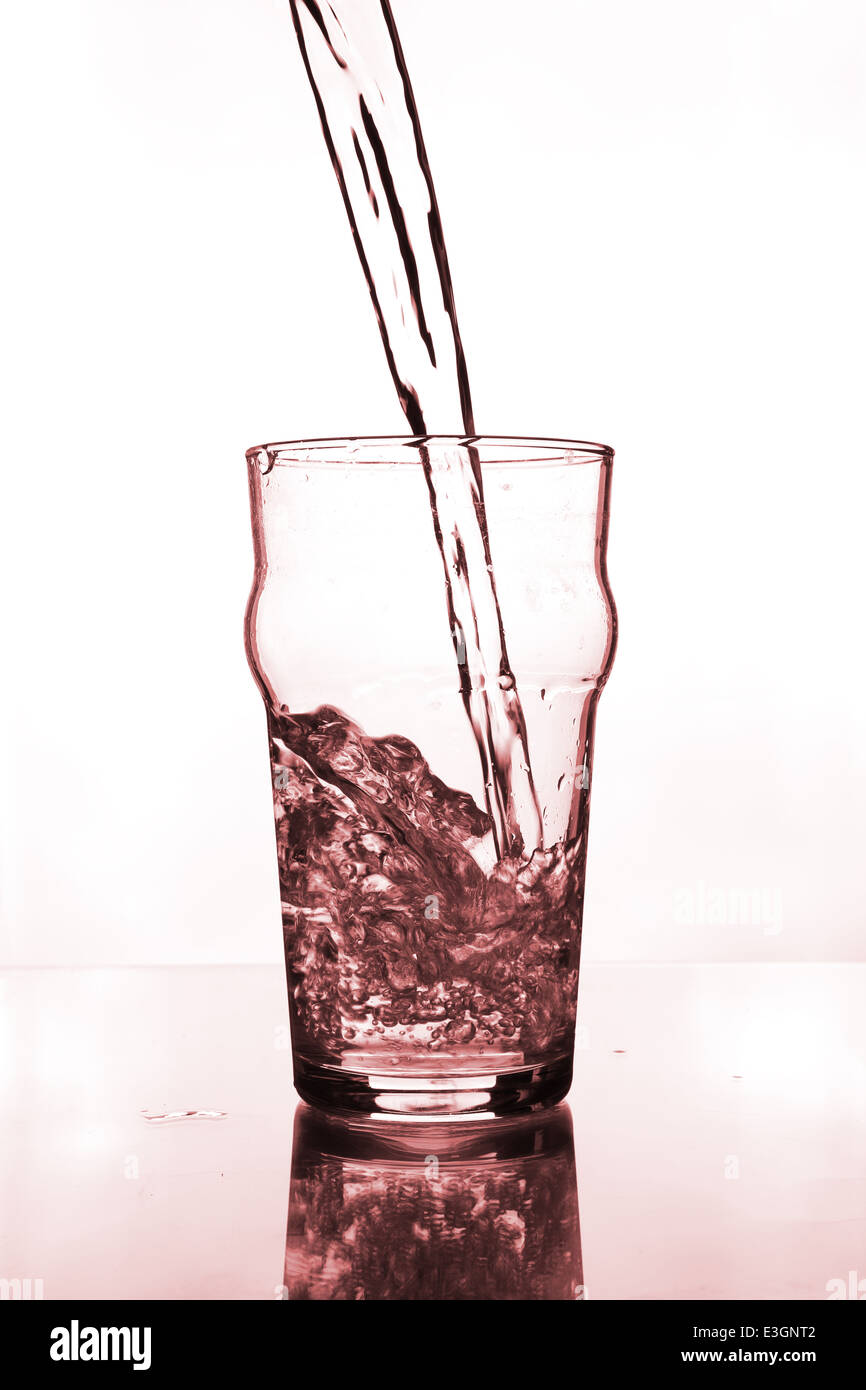 glass with water pouring on glass table Stock Photo - Alamy