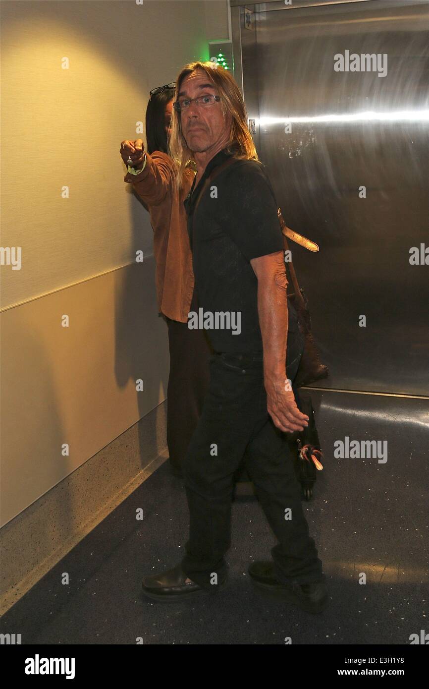 Iggy Pop running late at LAX and he quickly waves hello and goodbye at ...