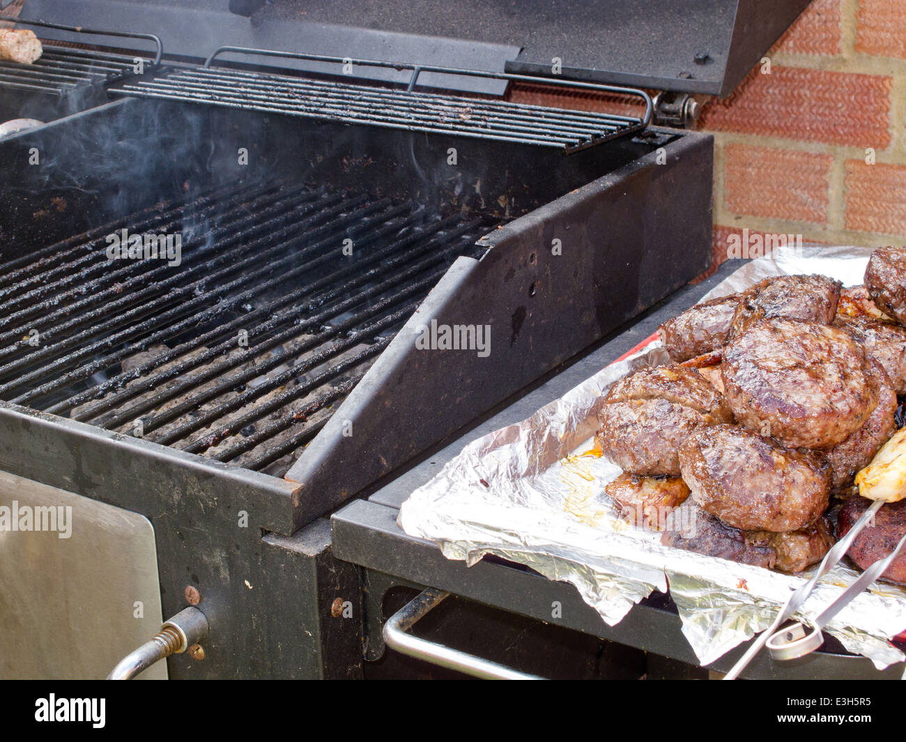 A BBQ with burgers and chicken by the side after being cooked Stock ...