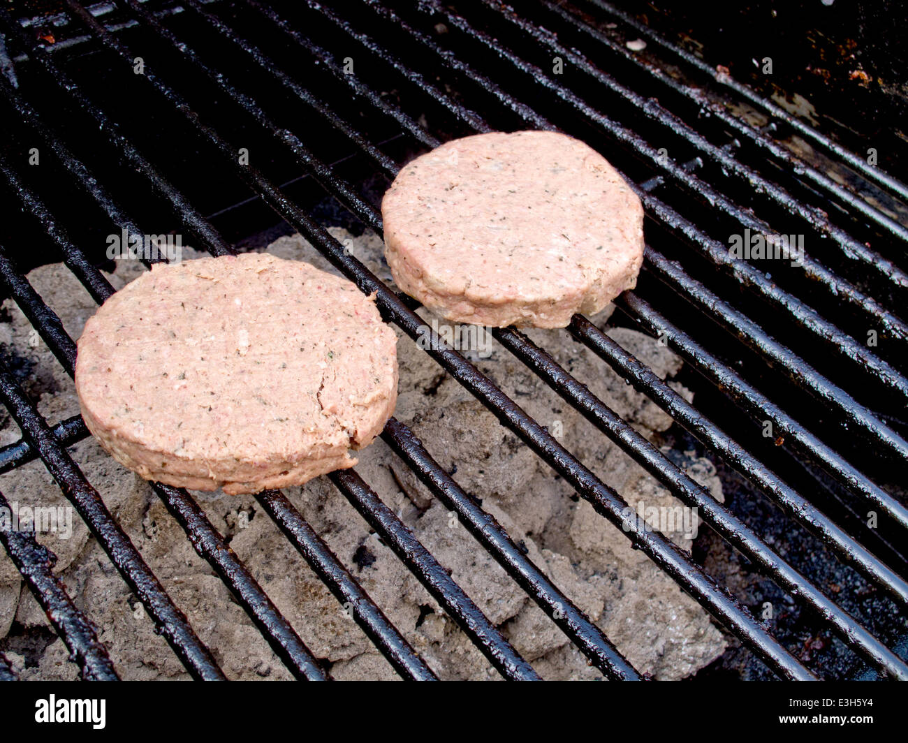 Burgers cooking on a BBQ Stock Photo - Alamy