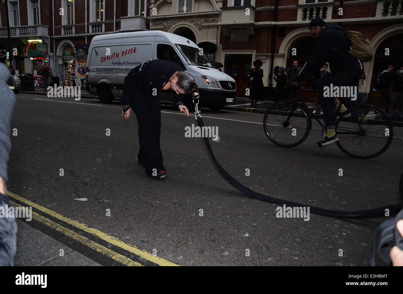 Circus performer from the Circus Of Horrors pulls a hearse with her ...