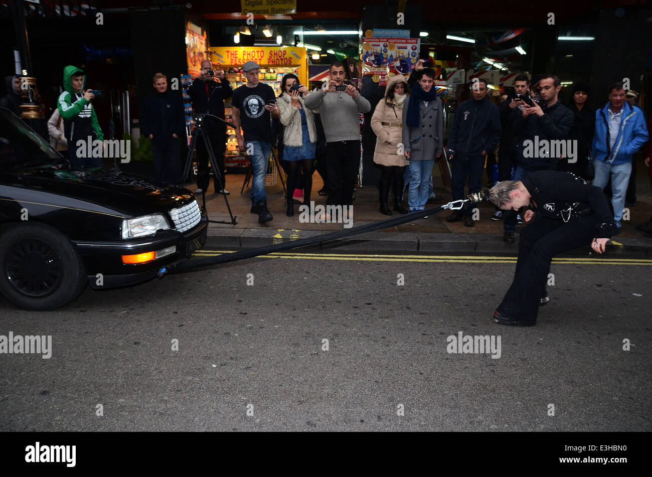 Circus performer from the Circus Of Horrors pulls a hearse with her ...