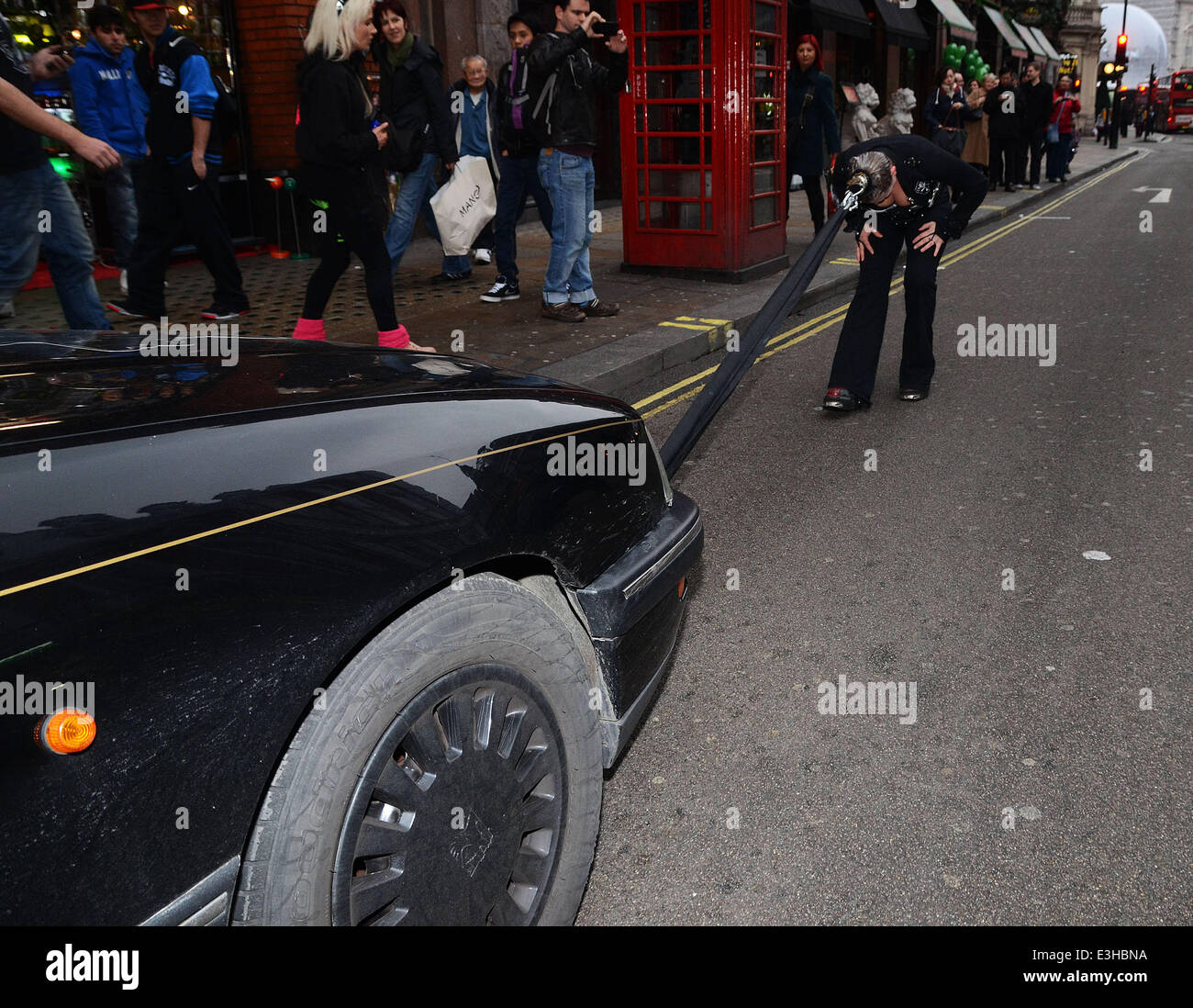 Circus performer from the Circus Of Horrors pulls a hearse with her ...