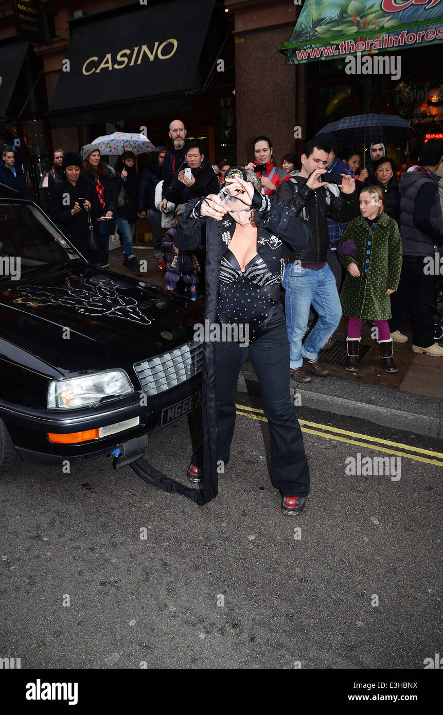 Circus performer from the Circus Of Horrors pulls a hearse with her ...