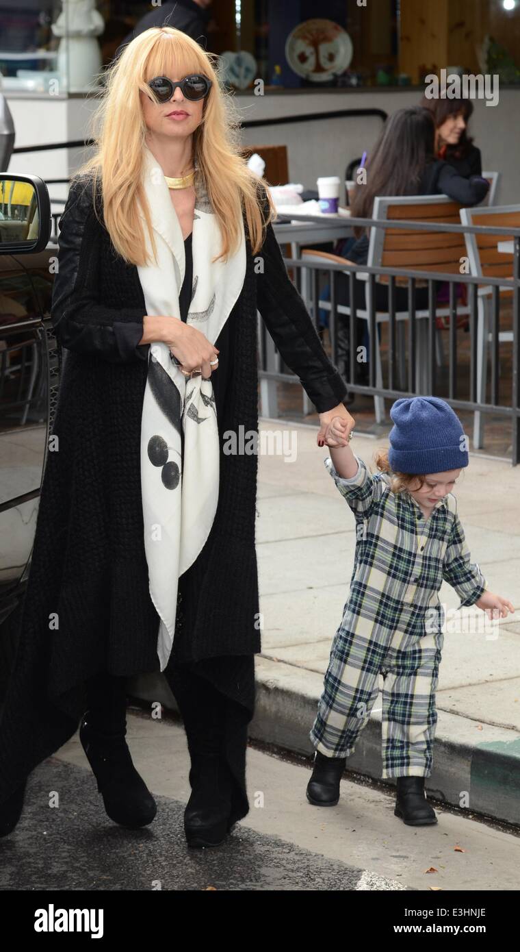 Rachel Zoe in mono, wearing a long knitted coat, black boots and long ...