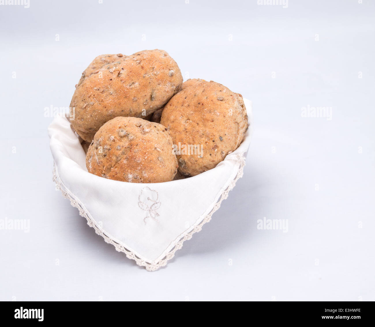 Brown/granary bread buns/baps in a basket with a serviette Stock Photo ...